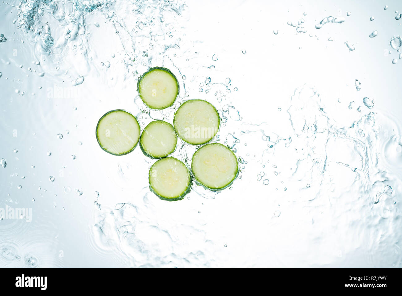 Zucchini Water Splash on white background Stock Photo - Alamy