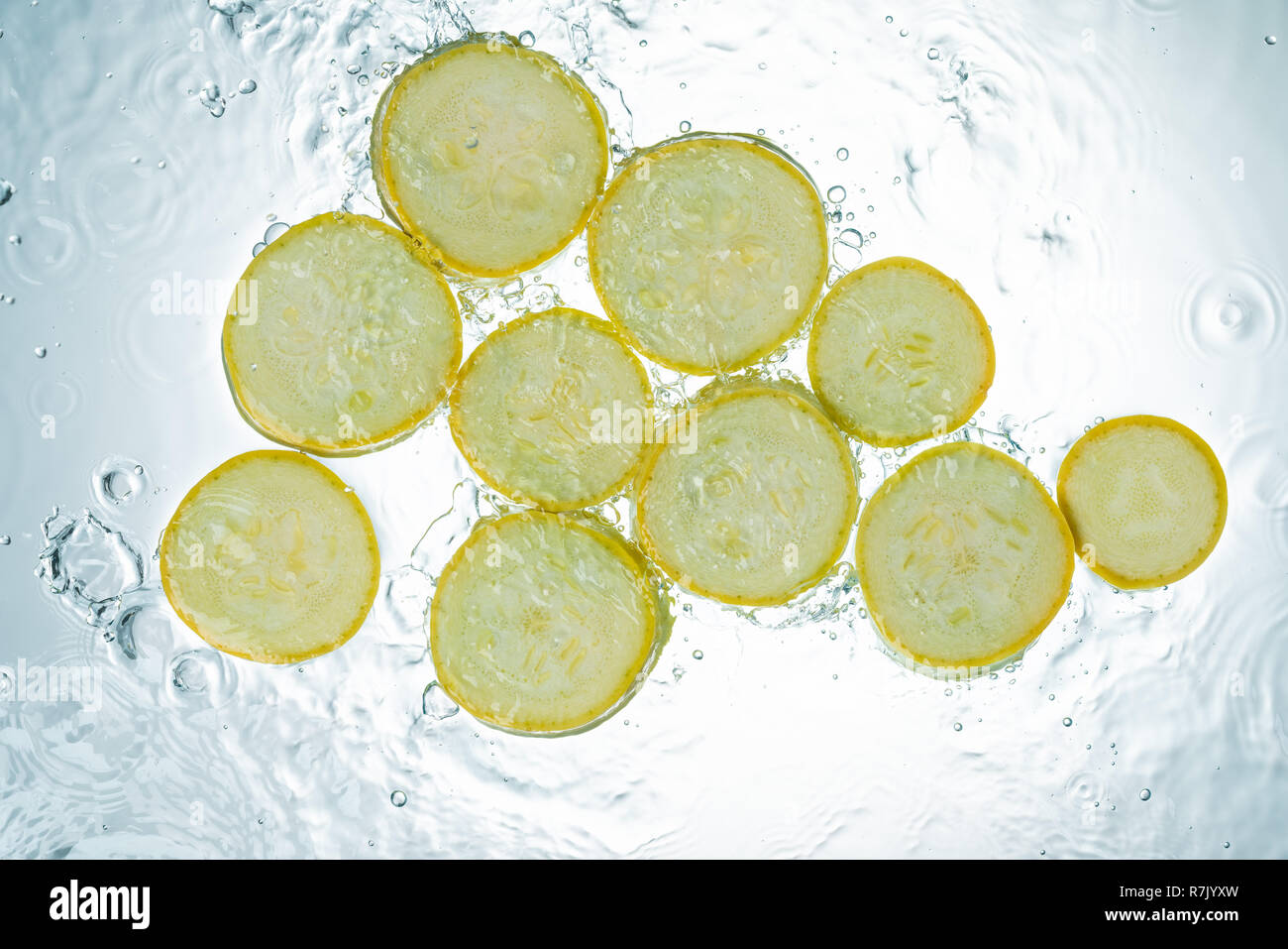Zucchini Water Splash on white background Stock Photo - Alamy