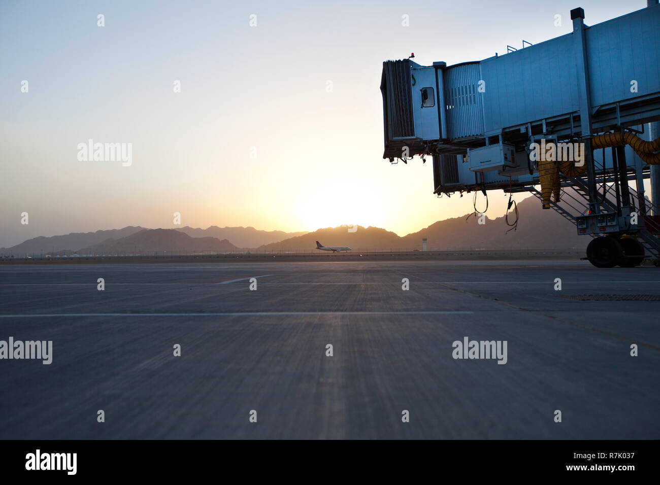 Airport terminal boarding gate with sunset background Stock Photo - Alamy
