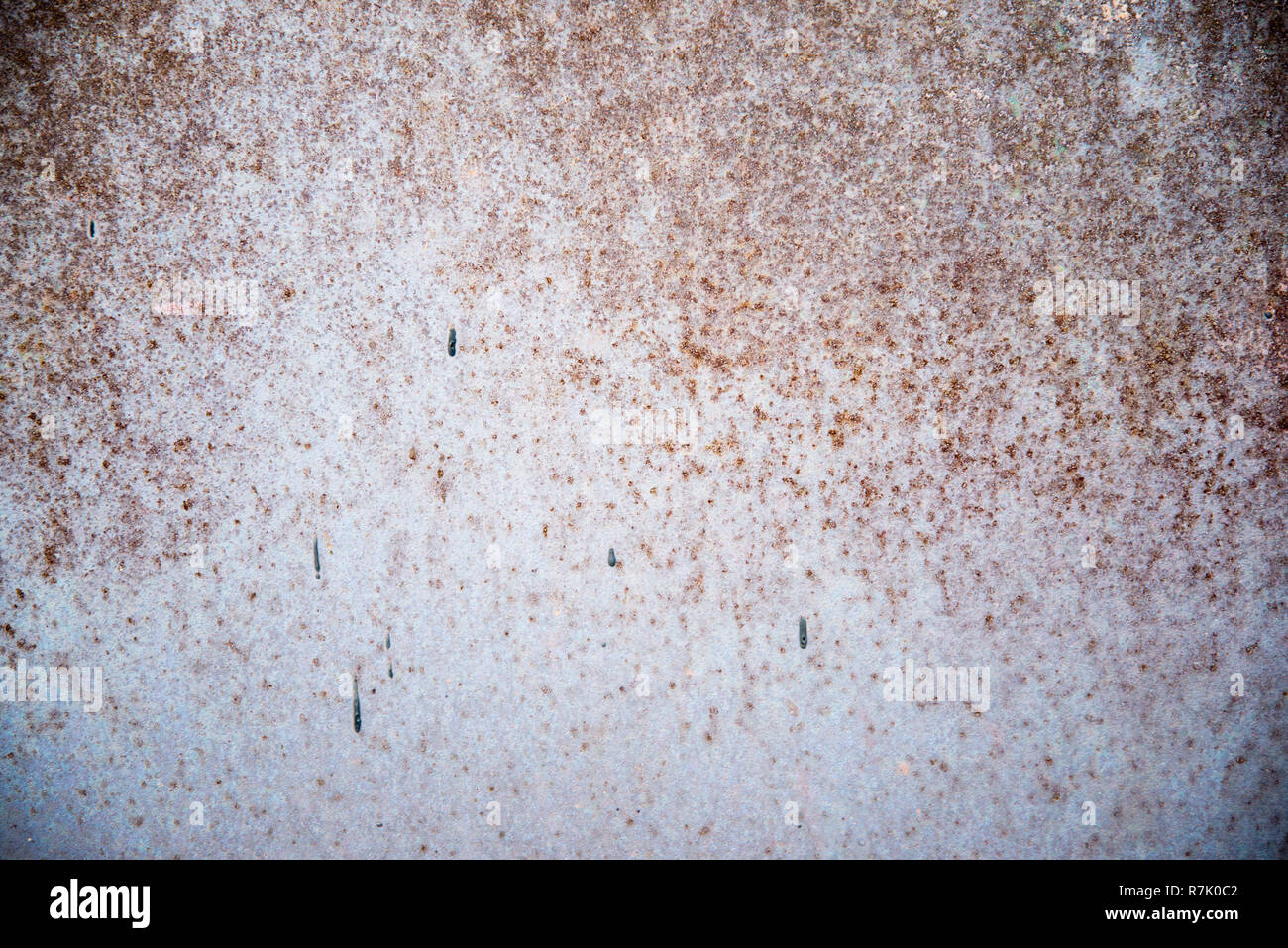 small rust stains on a light blue background Stock Photo - Alamy