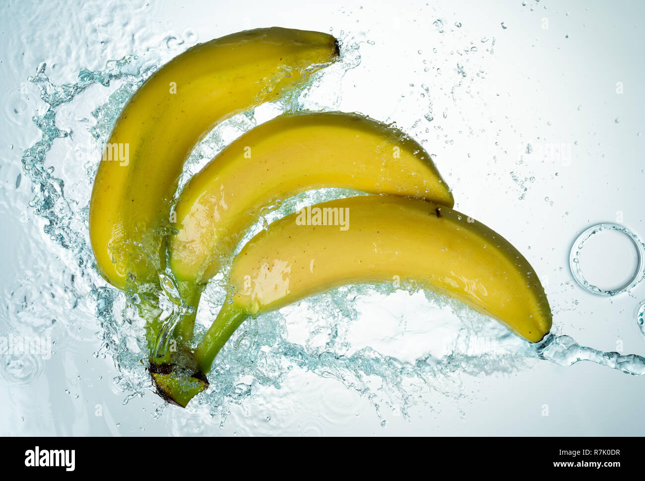 Bananas Water Splash on white background Stock Photo - Alamy