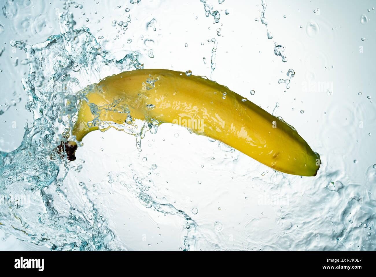 Bananas Water Splash on white background Stock Photo - Alamy