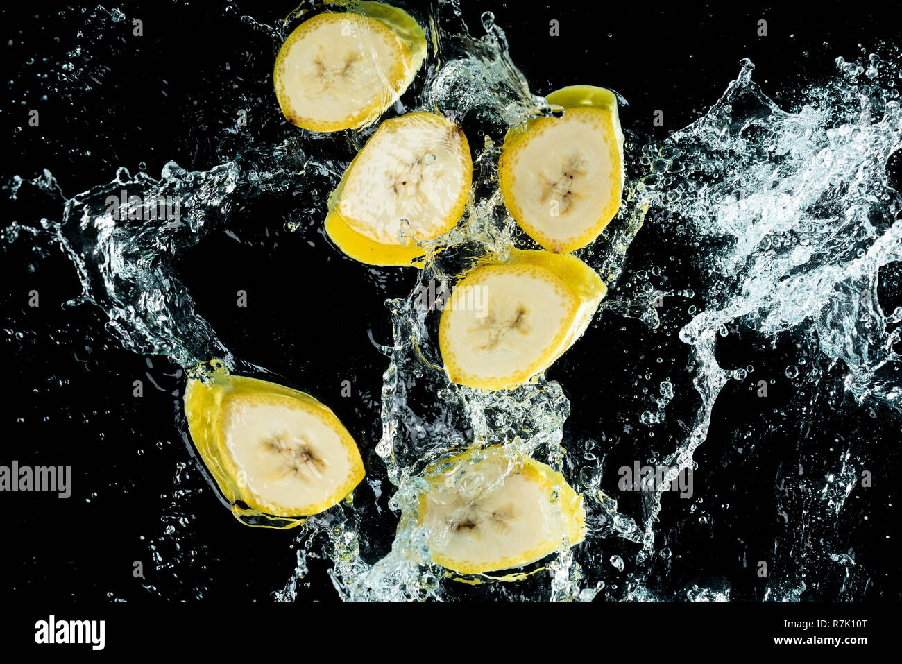 Bananas Water Splash on white background Stock Photo - Alamy