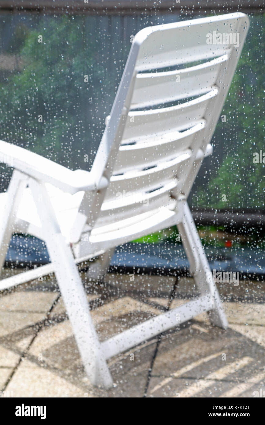 Garden chair in the rain Stock Photo - Alamy