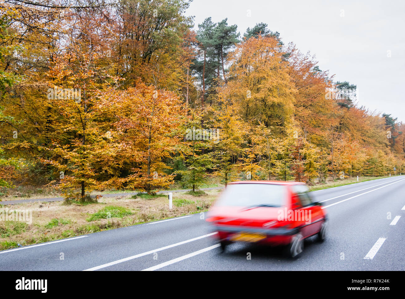 Car driving on country road. Autumn scene, low angle, motion blur Stock ...