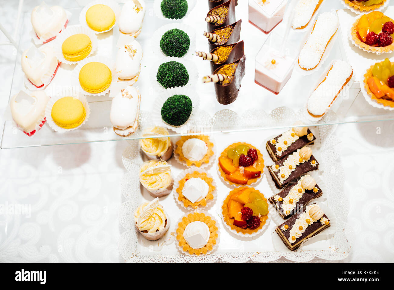 Table with different sweets for party. Candy bar Stock Photo - Alamy