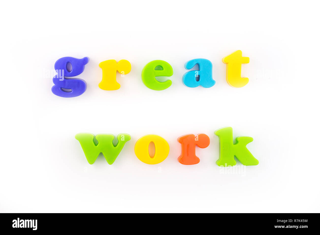Great work colourful plastic letters isolated on the white .Concept of ...