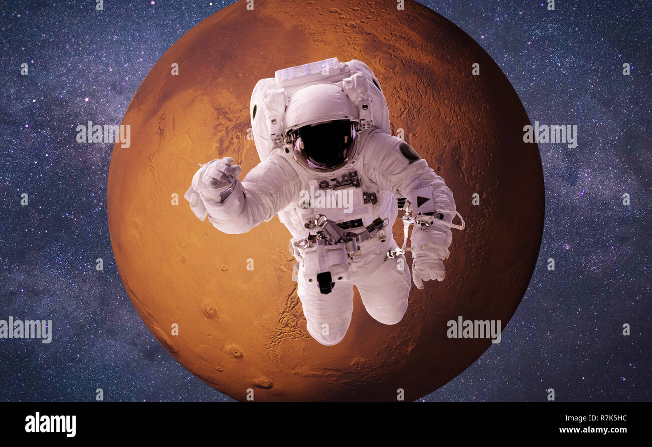 astronaut performing a space walk around the red planet Mars Stock ...