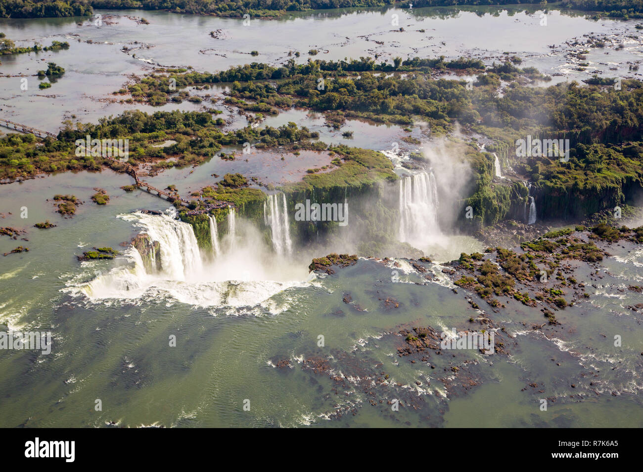 Aerial view of beautiful Iguazu Falls Devil's Throat chasm from a helicopter flight. Brazil and ...