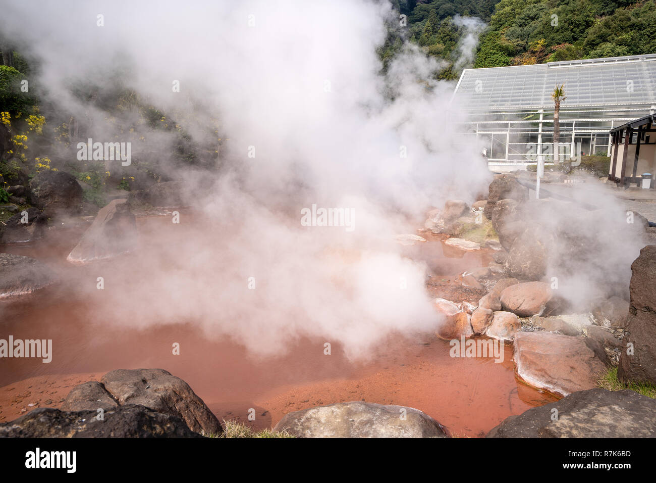 Red hot spring near UMI JIGOKU (Sea Hell) pond in autumn, which is one ...