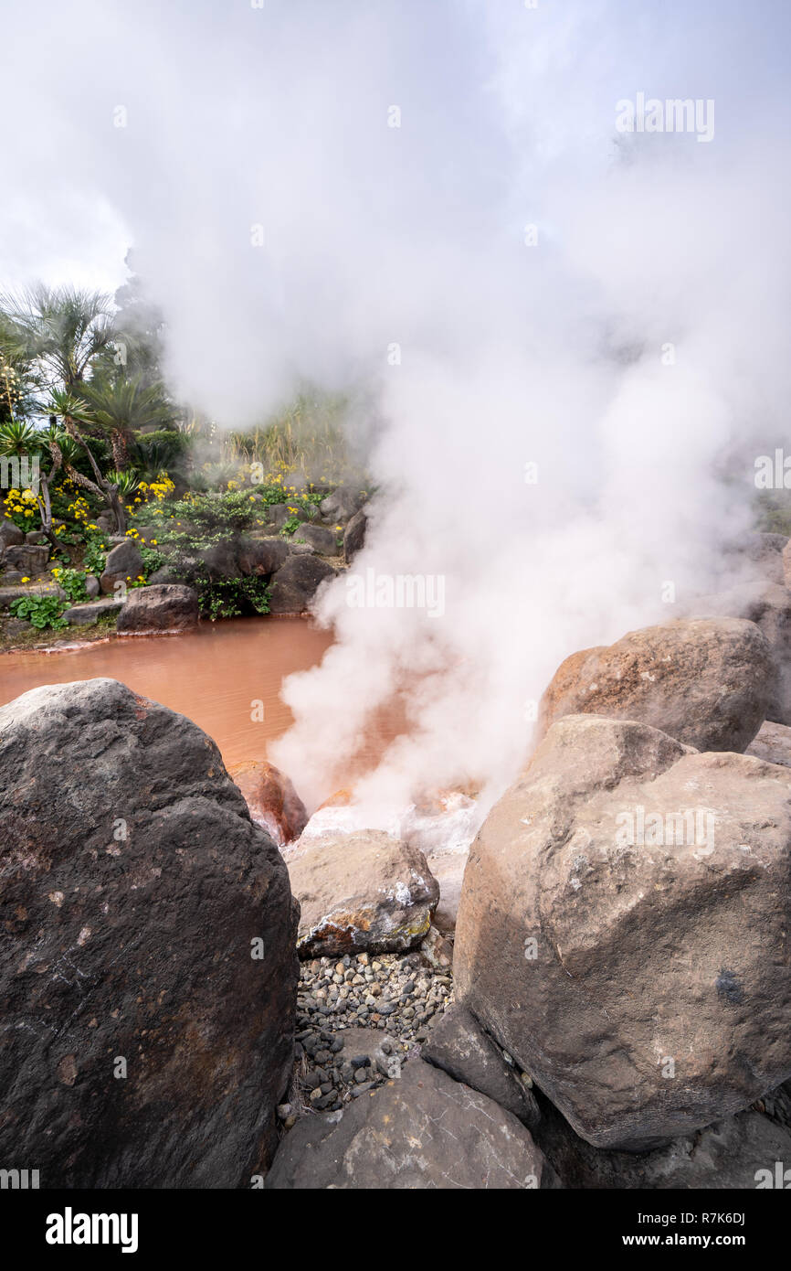 Red hot spring near UMI JIGOKU (Sea Hell) pond in autumn, which is one ...