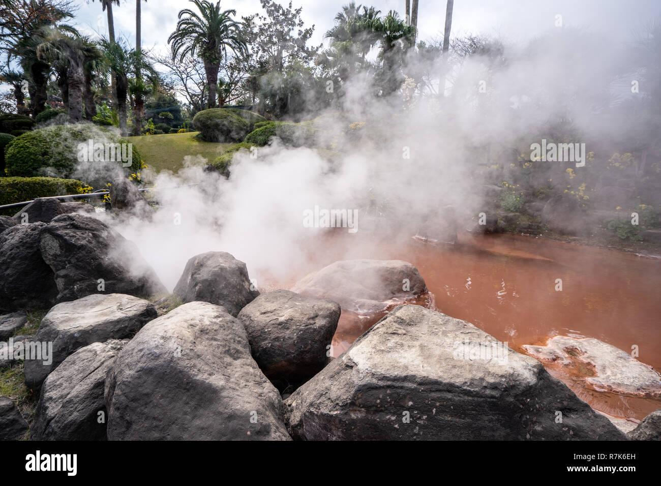 Red hot spring near UMI JIGOKU (Sea Hell) pond in autumn, which is one ...