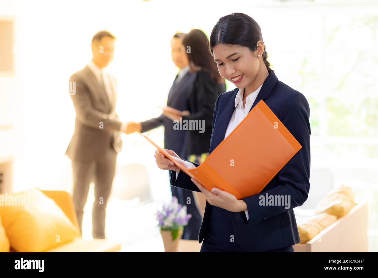 Portrait of Asian Businesswoman hold working file with business team in ...