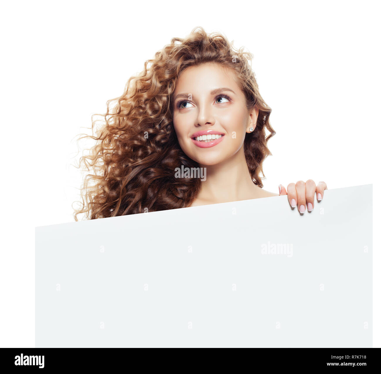 Young smiling woman with white empty paper board background isolated on ...
