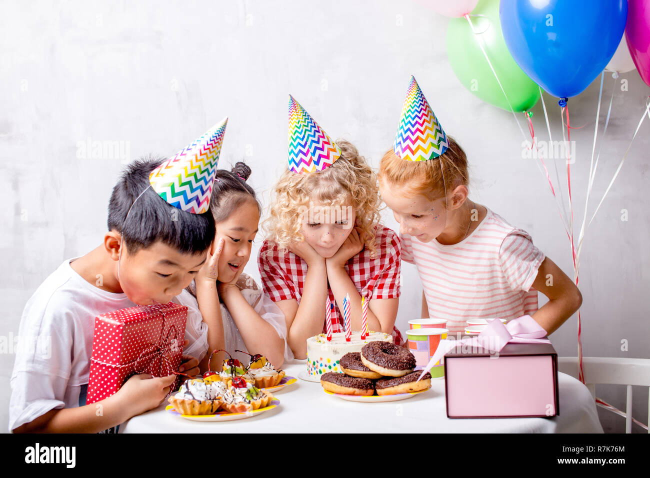 awesome little girls and boys are waiting for their porsion of cake ...