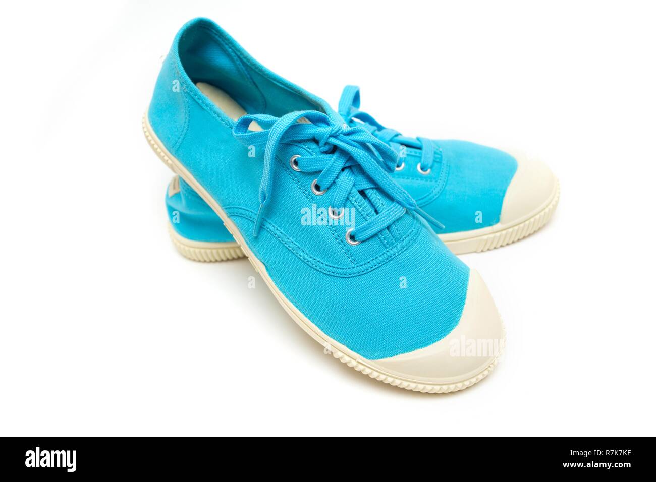 bright blue sneakers on a white background Stock Photo - Alamy