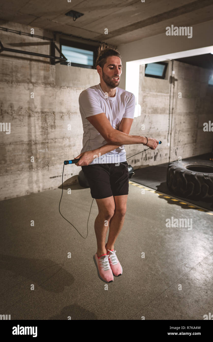 Young man using skipping rope hi-res stock photography and images - Alamy