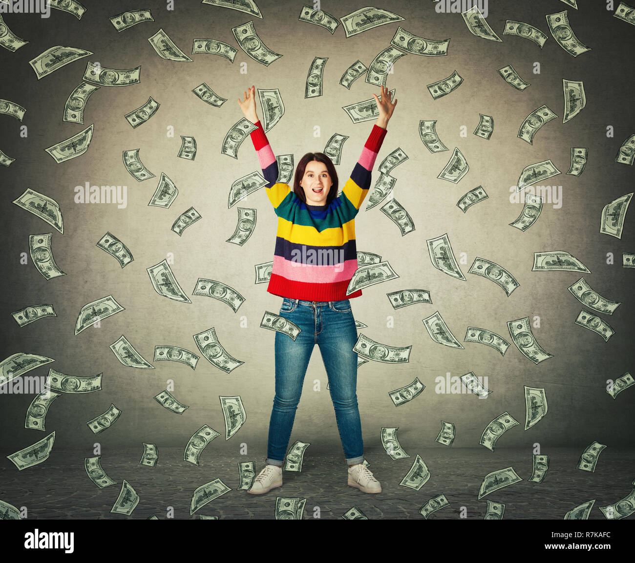 A happy young womanfull length portrait with arms raised up celebrate ...