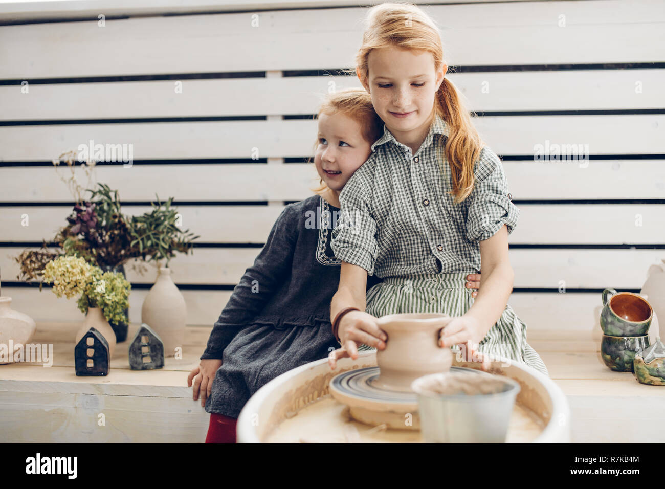 happy adorable children making a pottery on pottery wheel Stock Photo ...