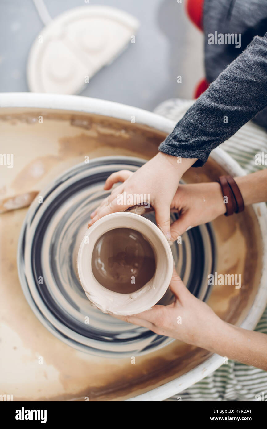 top view shot. children's arms holding ready pottery Stock Photo - Alamy