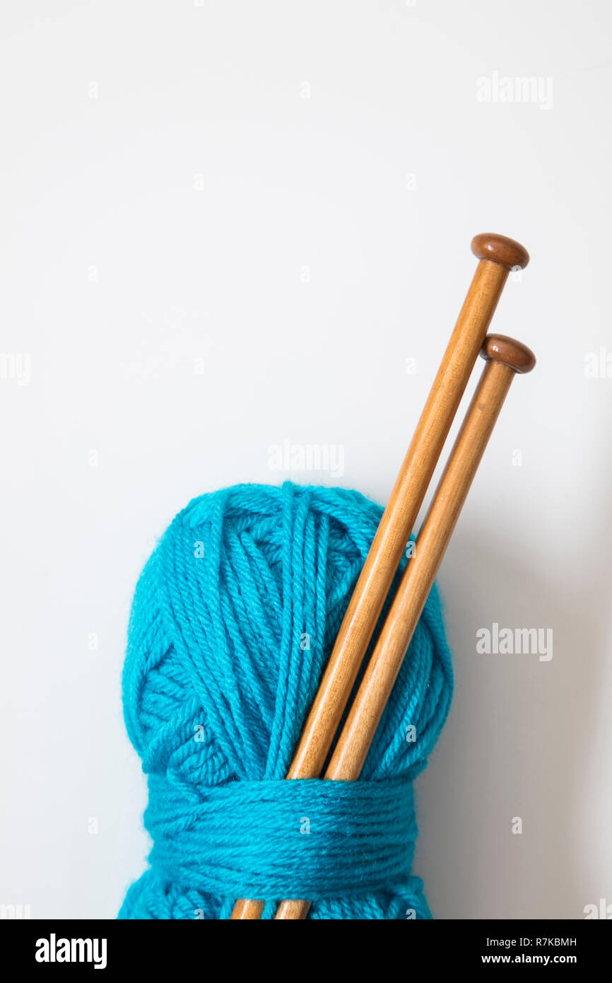 A ball of turquoise blue wool with wooden knitting needles Stock Photo ...