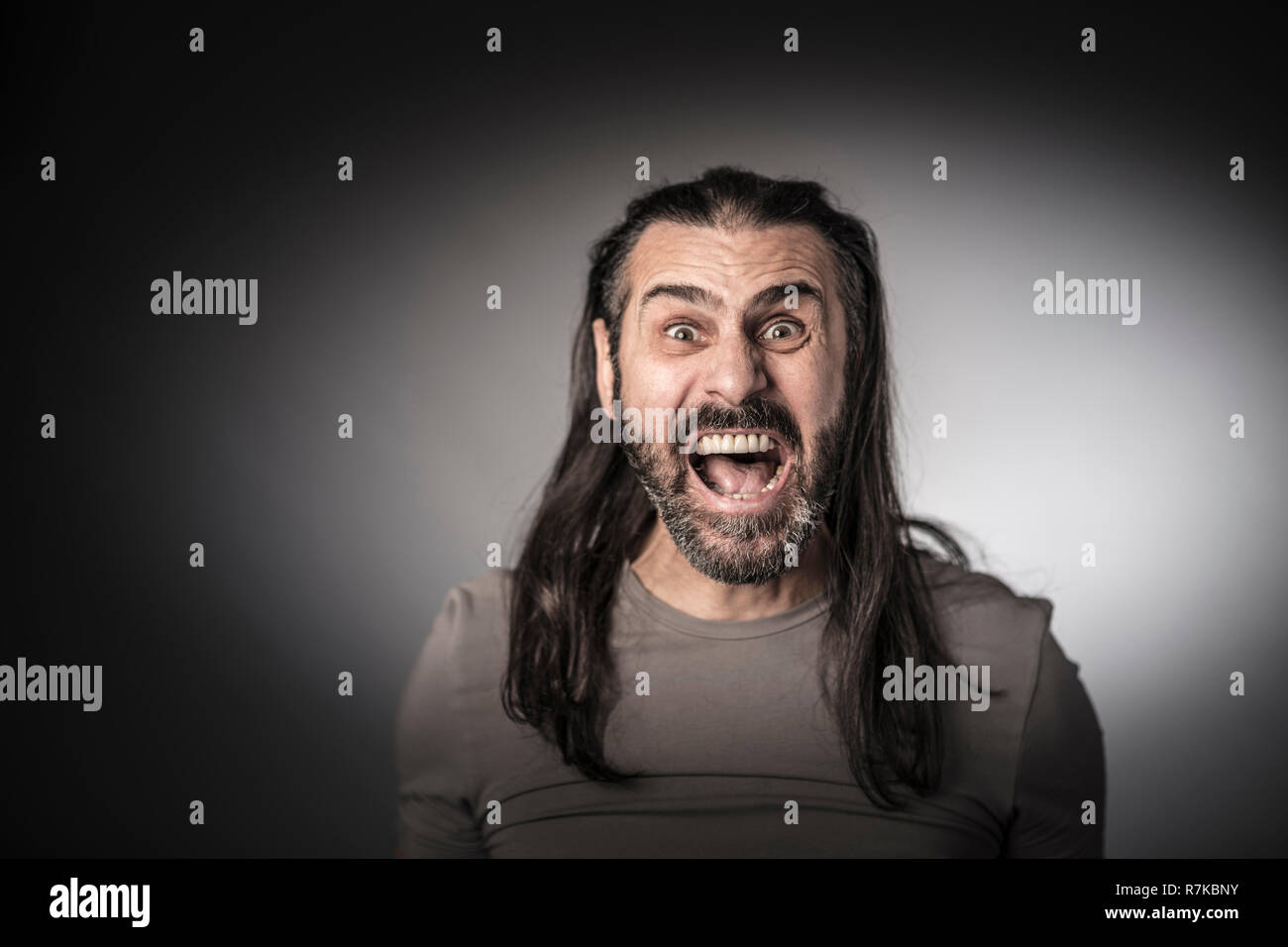 studio portrait of stressed long hair man Stock Photo - Alamy