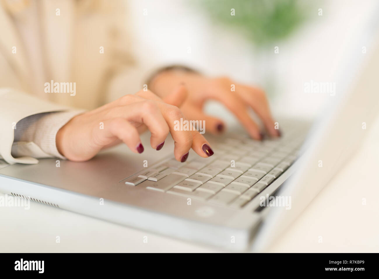 Close-up of female hand with painted nails on the keyboard of the ...