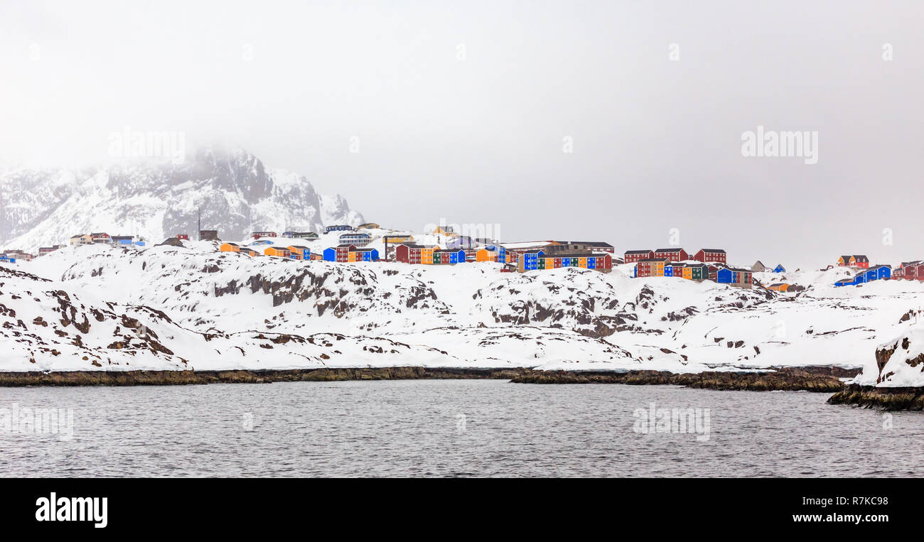 Rows of colorful Inuit living houses of Sisimiut town, on the steep ...