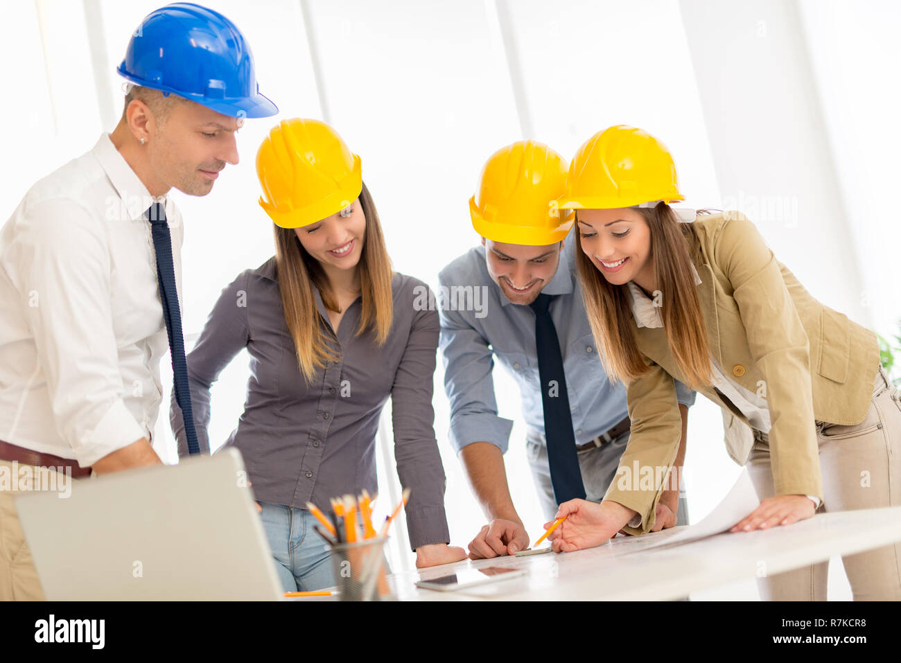 Successful architect team checking the projects Stock Photo - Alamy