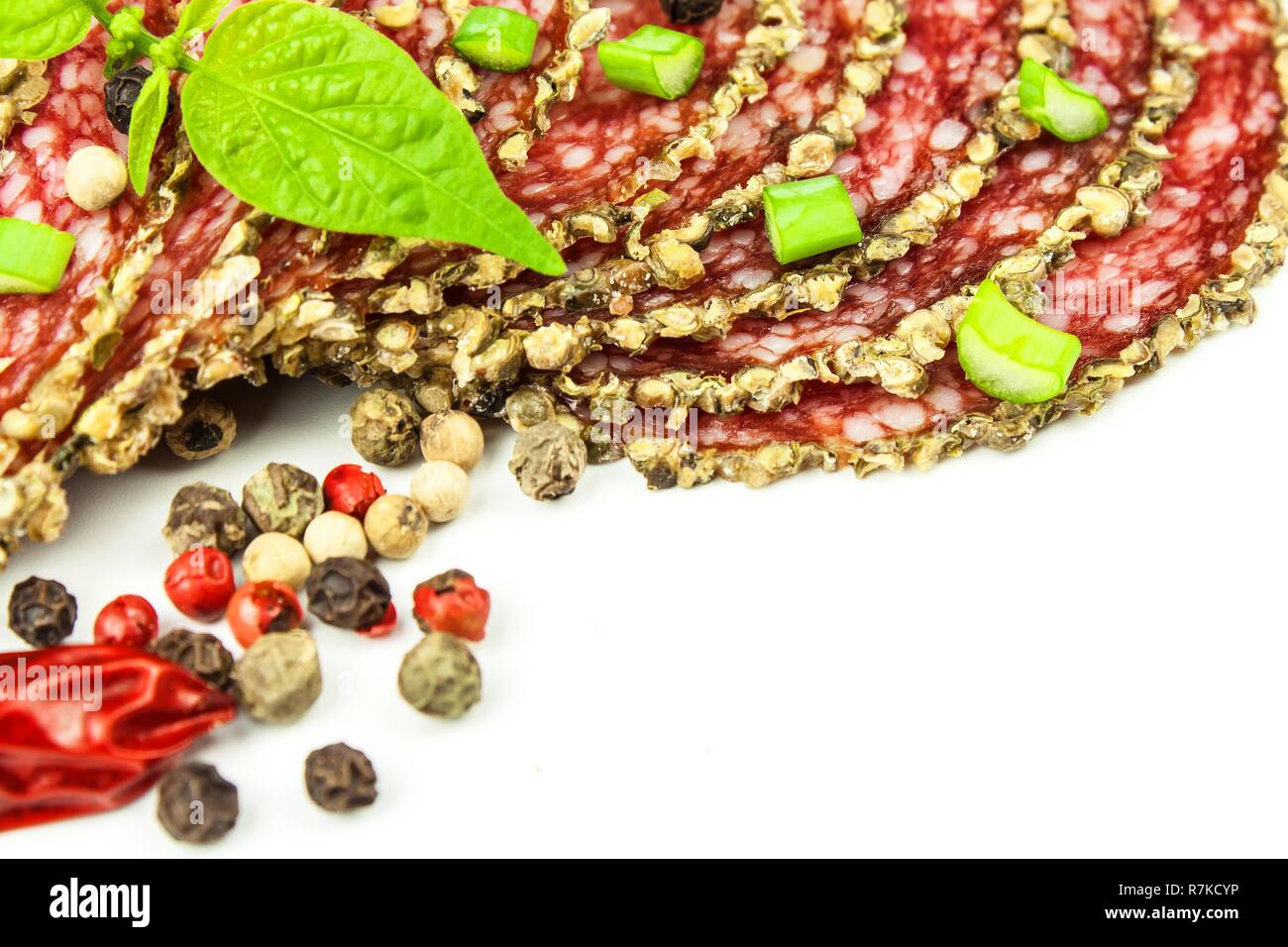 Dried organic salami sausage covered with pepper on white background ...