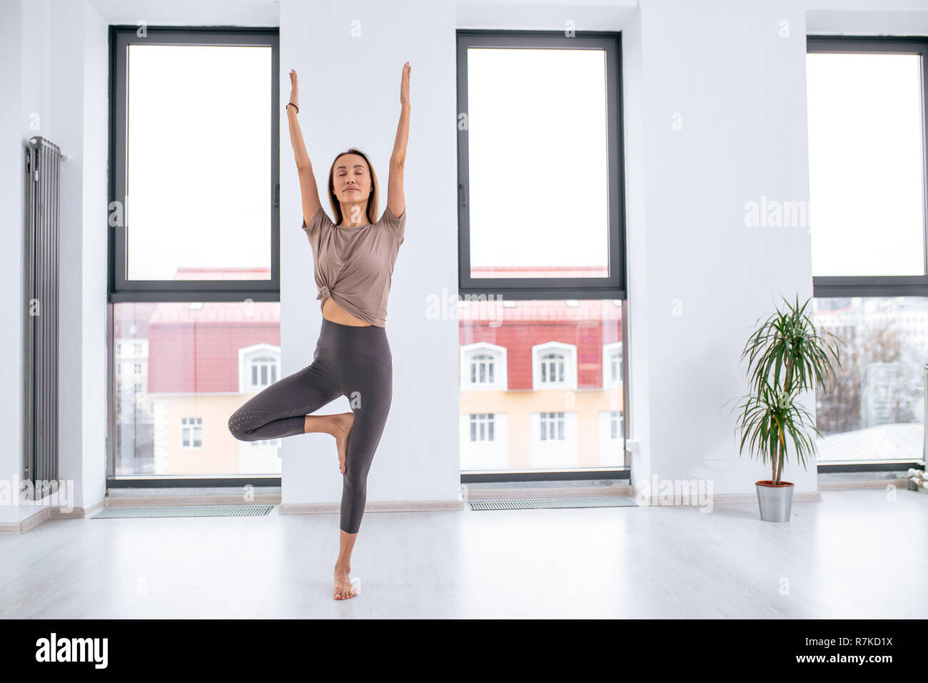 yoga position with raised straighted arms Stock Photo - Alamy