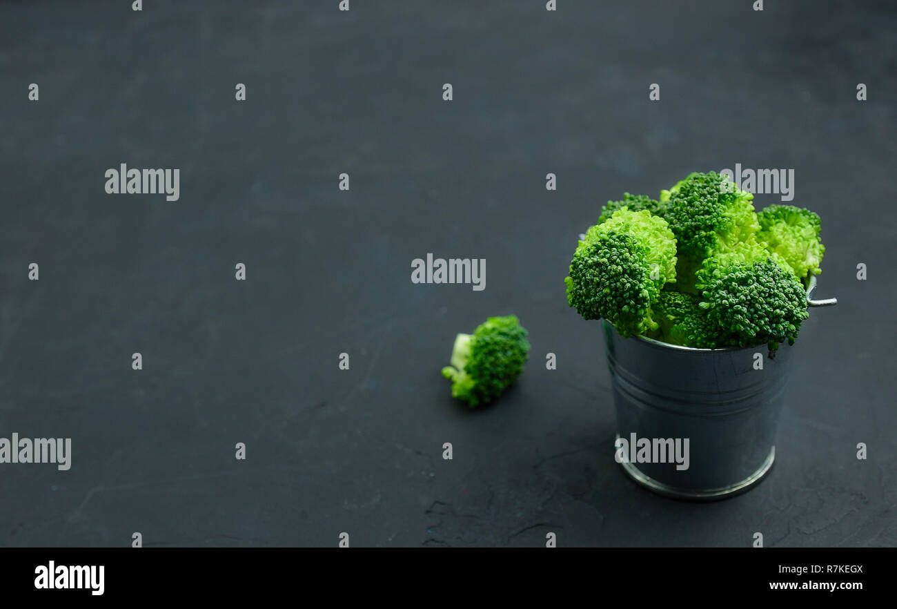 Healthy food Fresh broccoli in a bucket on a black background. vertical ...