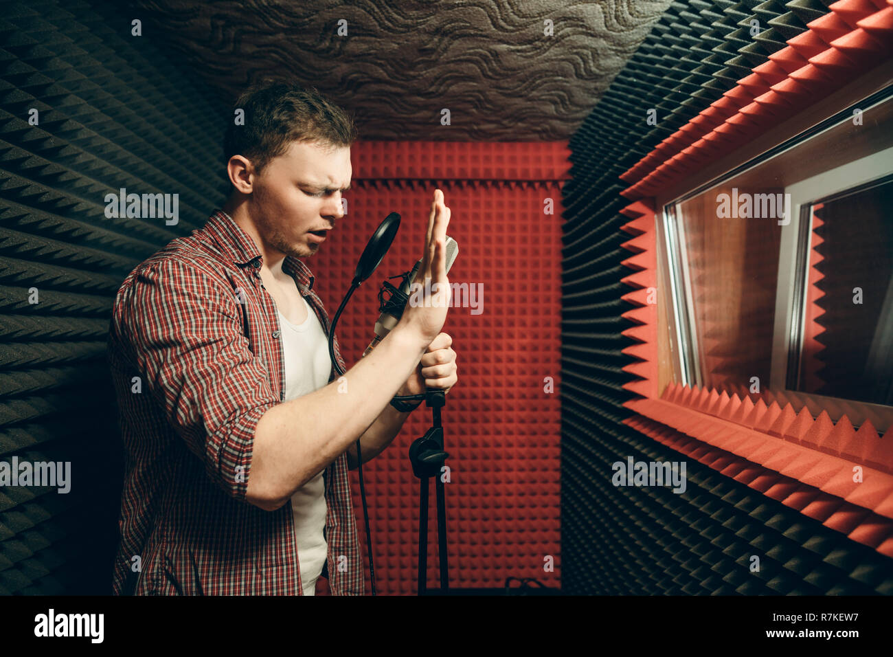 talented singer ecording his own song in the modern studio Stock Photo ...