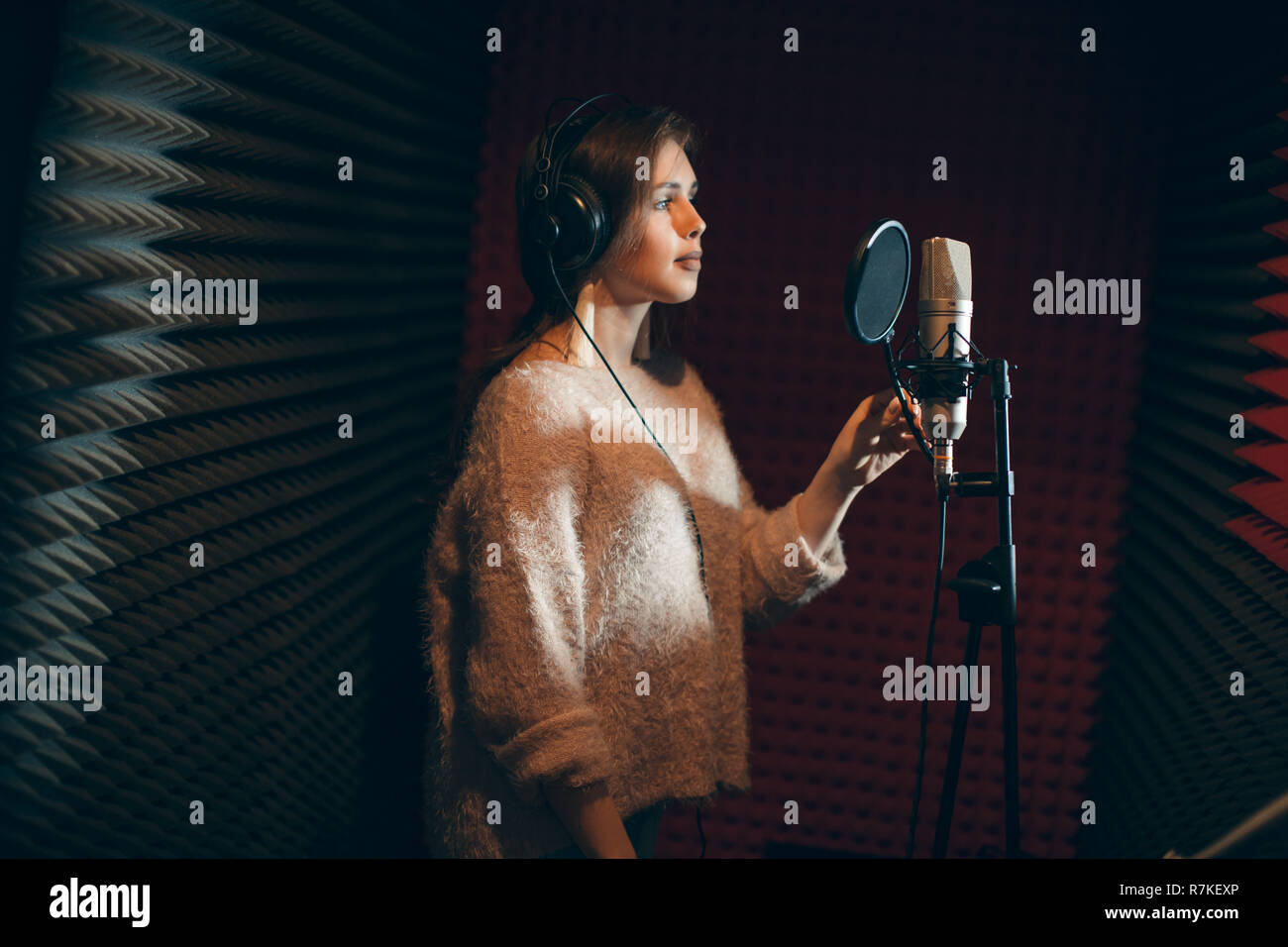 Young serious attractive woman singing in a recording studio Stock ...