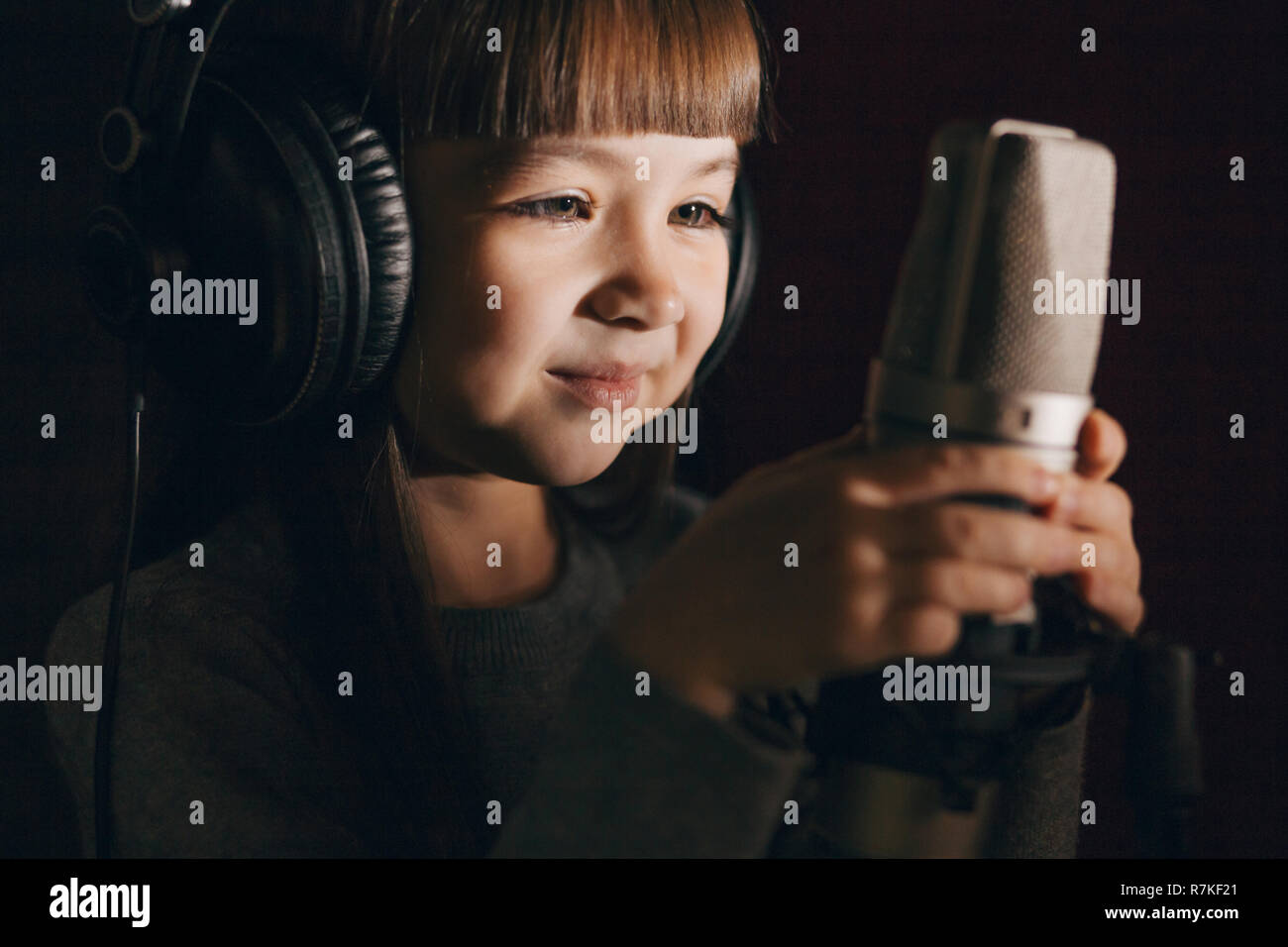 beautiful kid holding the microphone in her first performance Stock ...