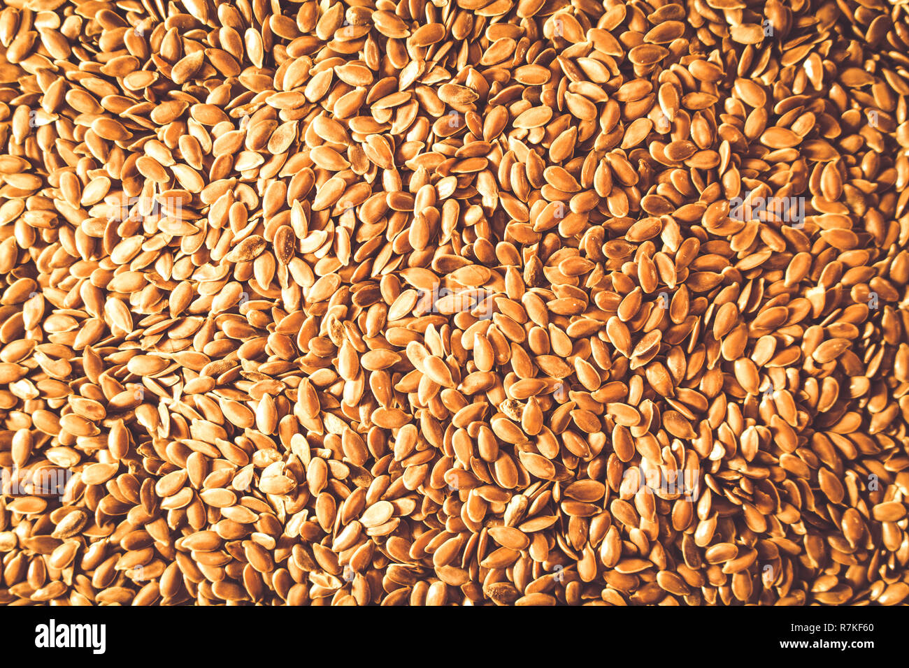 Flax seed, a lot on the whole background Stock Photo - Alamy