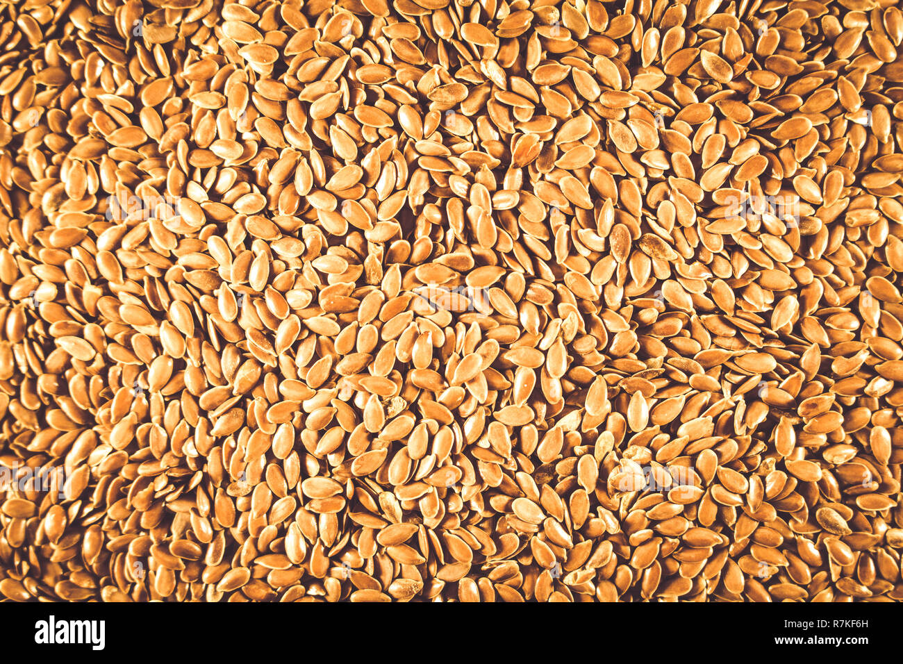 Flax seed, a lot on the whole background Stock Photo - Alamy