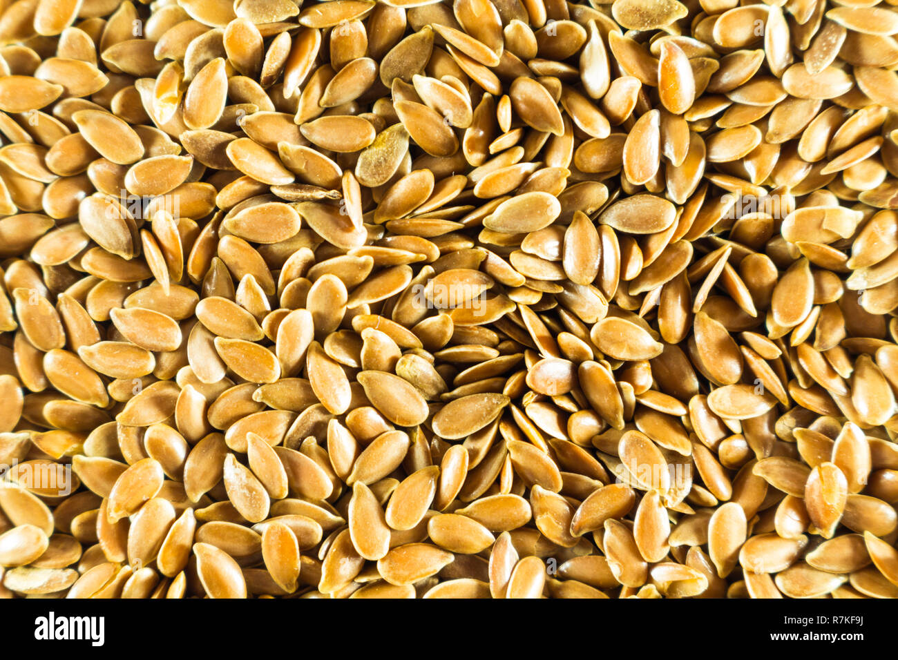 Flax seed, a lot on the whole background Stock Photo - Alamy