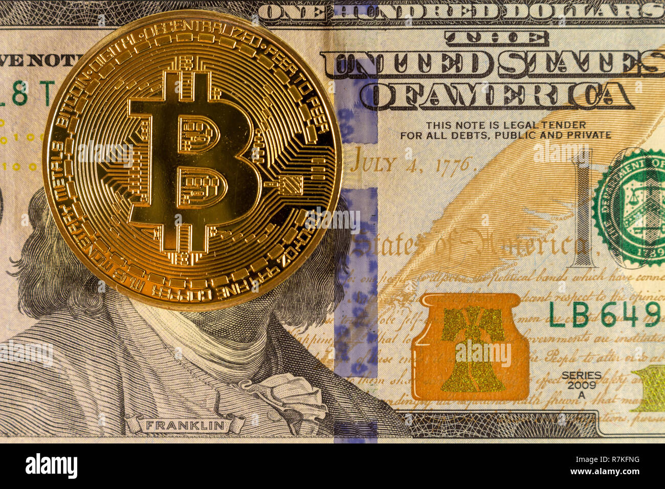 Bitcoin coin lies on a 100 dollar banknote Stock Photo - Alamy