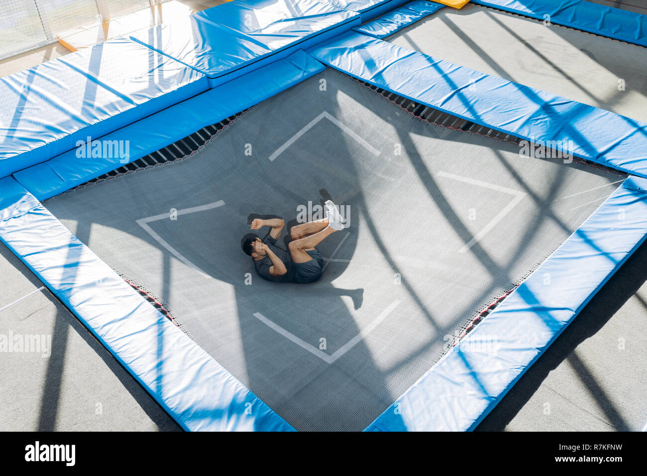 man trying to stand after landing on the back Stock Photo - Alamy