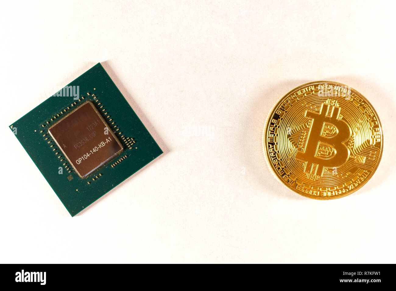 Bitcoin gold coin and video chip Stock Photo - Alamy