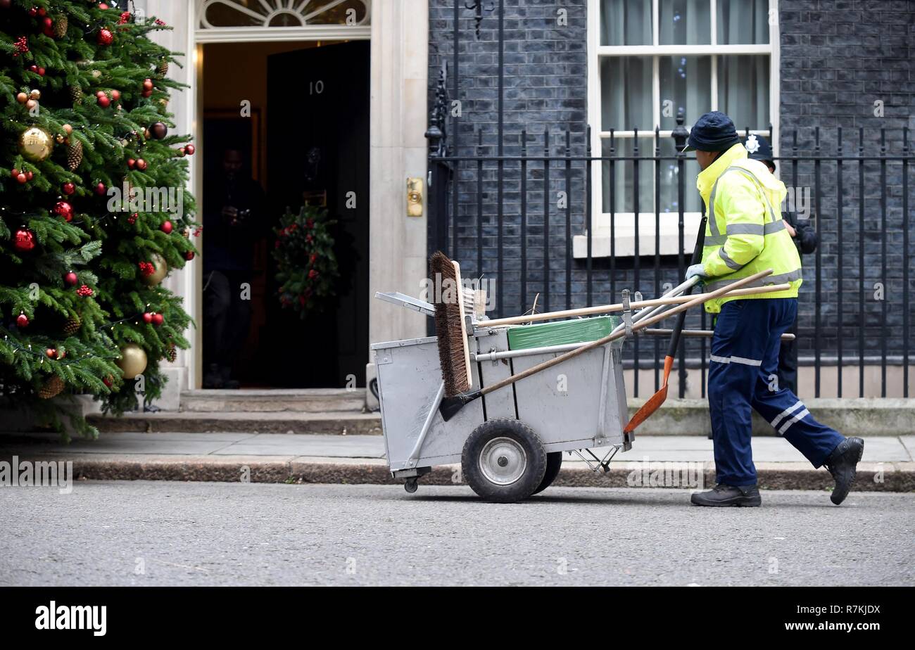 Street cleaner sweeps outside Number 10 Downing Street, Westminster ...