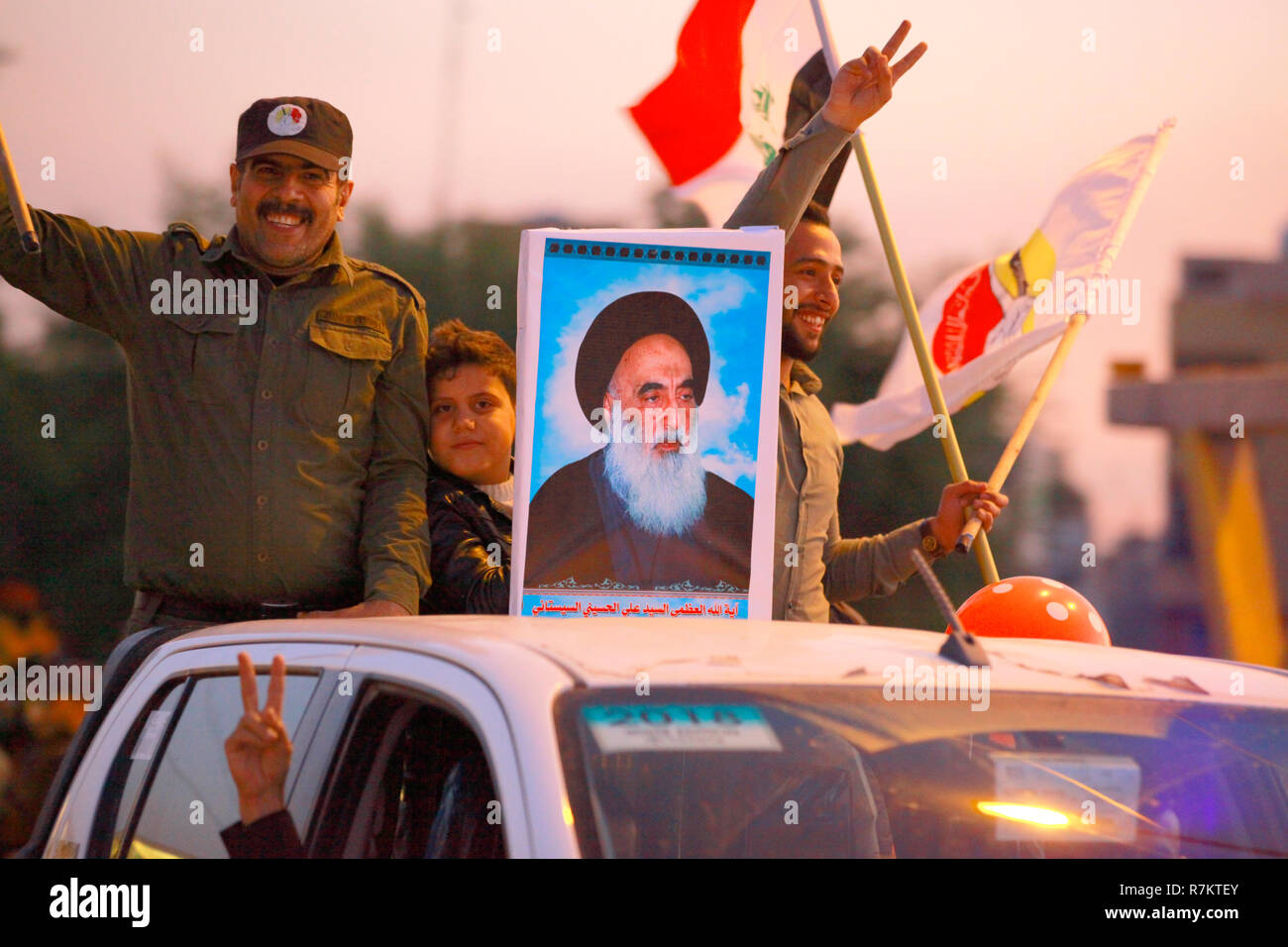 Baghdad, Iraq. 10th December, 2018. Iraqi people hold a poster of an ...