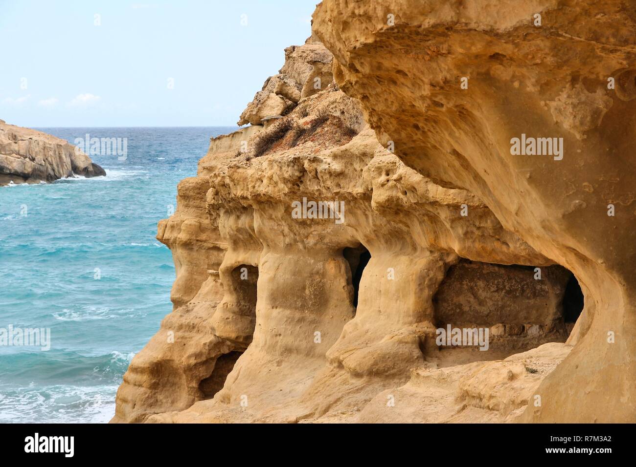 Coast of Crete island in Greece. Famous rock hewn ancient caves in ...