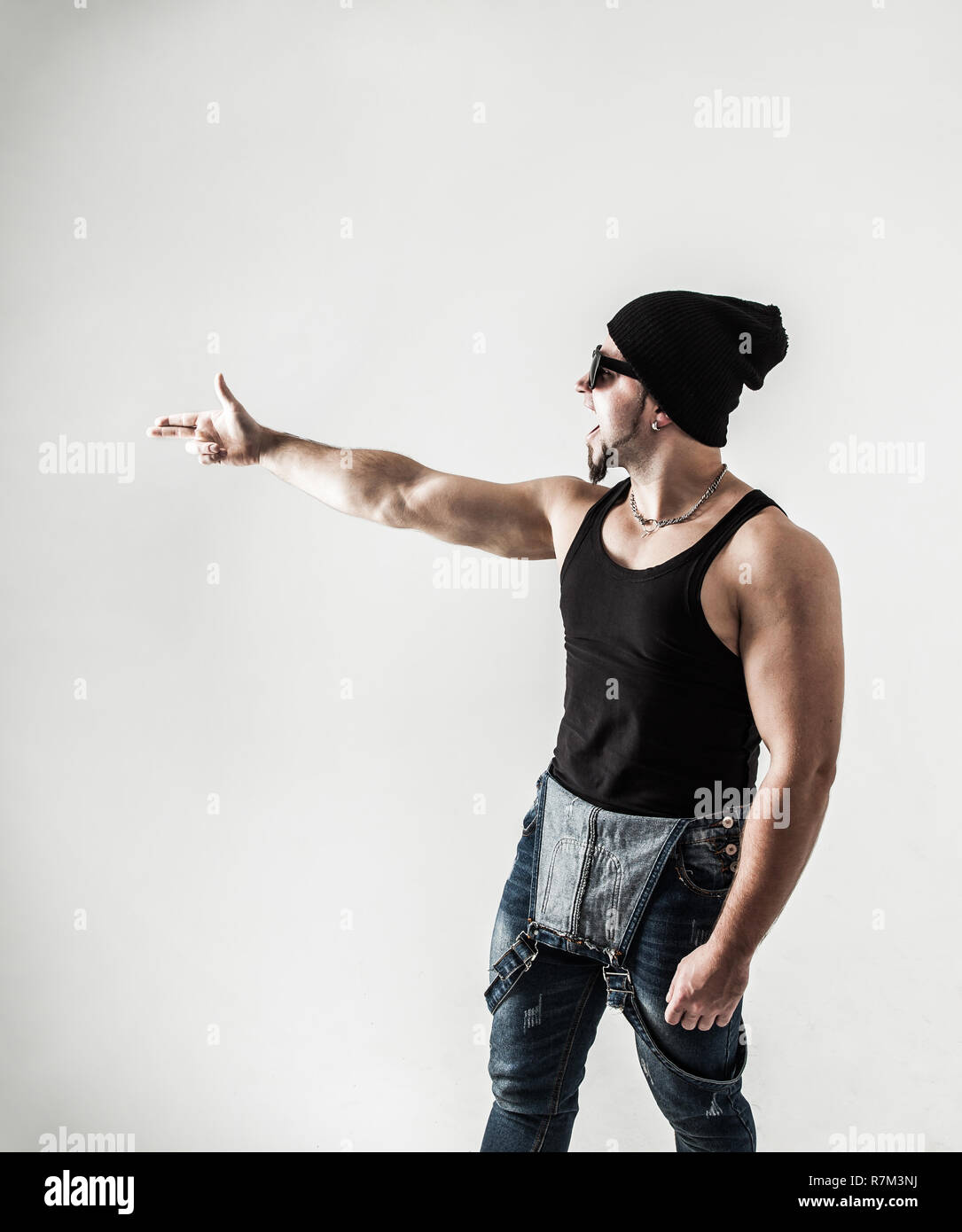 emotional and charismatic DJ - rapper with headphones on a light Stock ...