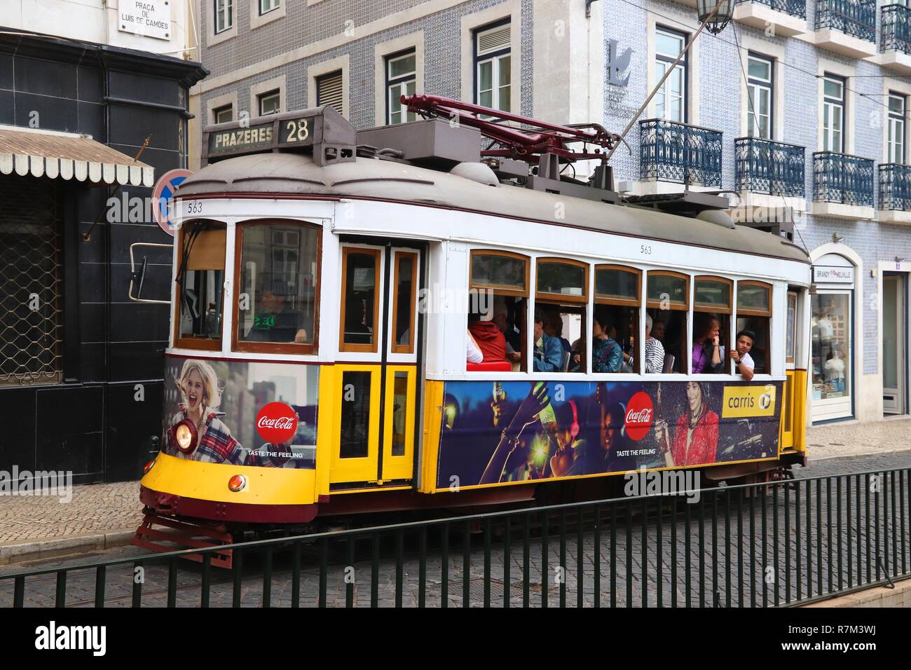 LISBON, PORTUGAL - JUNE 6, 2018: People ride the yellow tram Line 28 in ...