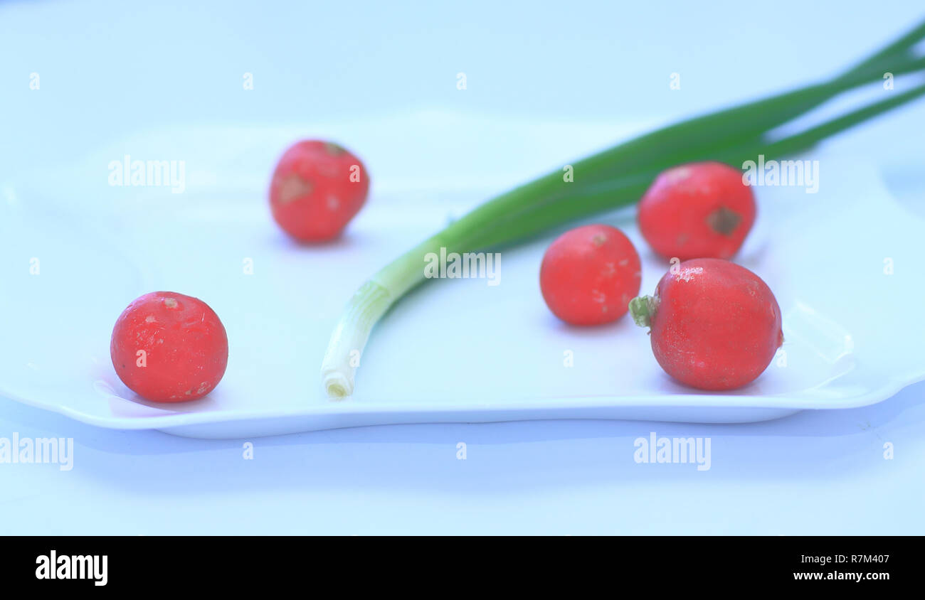 radish and green onion on light background Stock Photo - Alamy