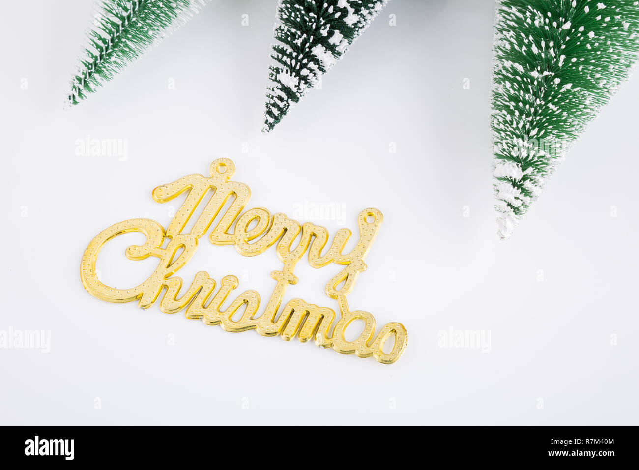 Decorated Christmas trees with golden Christmas text on white ...