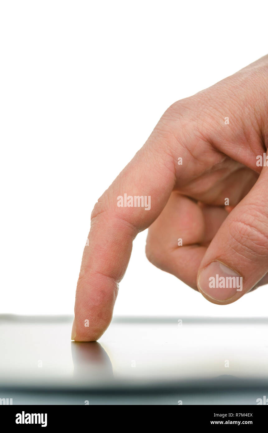 Side view of male finger working on a tablet computer. Over white ...