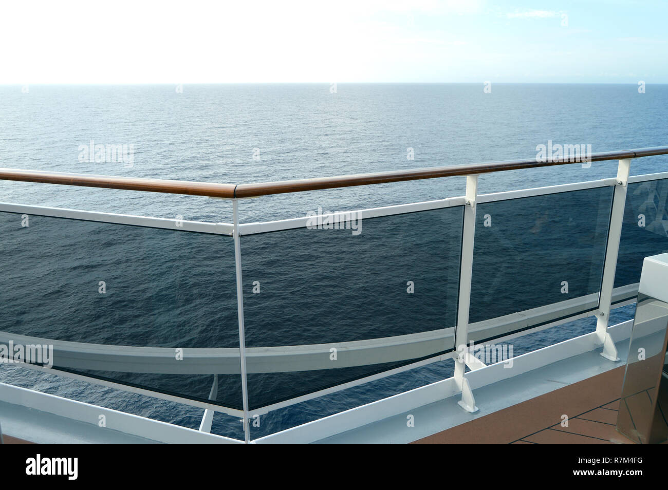 Sea view from the open deck of a modern cruise ship, railing and strong ...